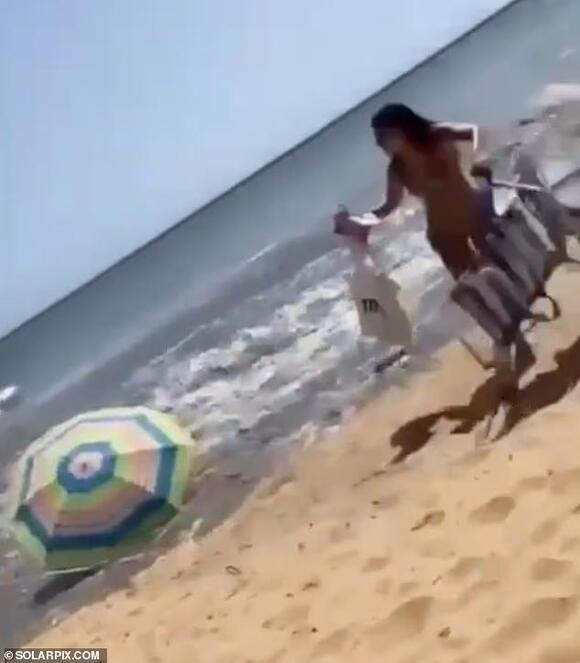 Moment beachgoers scream as 'mini-tsunami' hits south of Spain leaving ...