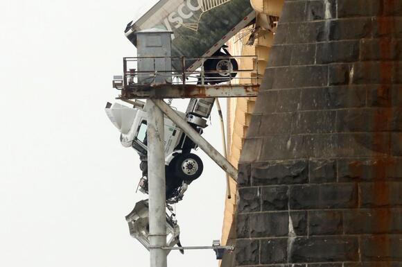 Driver rescued from semi-truck hanging off Louisville bridge