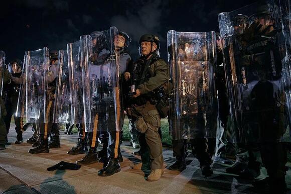 Riot police make multiple arrests as they clear protestors from Delaney ...