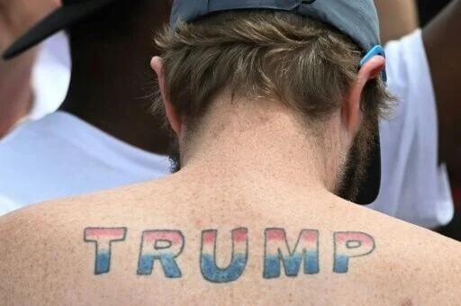 A man displays a 'Trump' tattoo during a campaign rally for former US ...