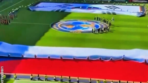 Wild Scene As Volunteer Gets Trapped Under Massive Flag During World ...