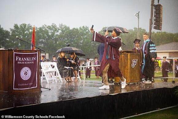 High school faces backlash as graduation is held in torrential downpour ...