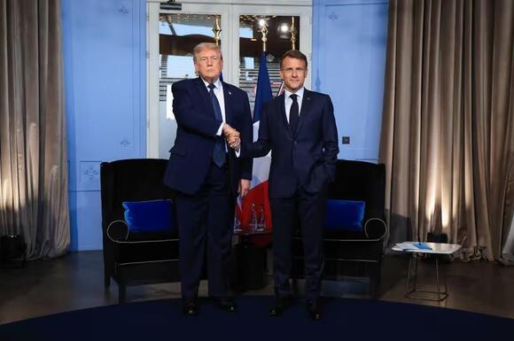 Donald Trump's odd 'dead fish' handshake with Emmanuel Macron as 'tired ...