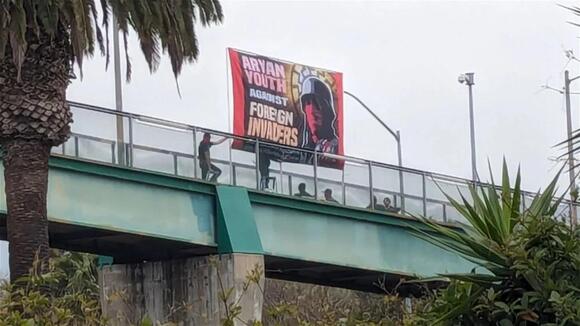 Discriminatory group display offensive sign on bridge Saturday morning