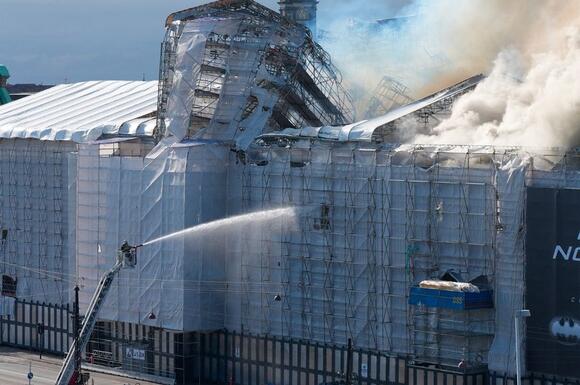 Copenhagen's old stock exchange on fire and spire of historic Borsen ...