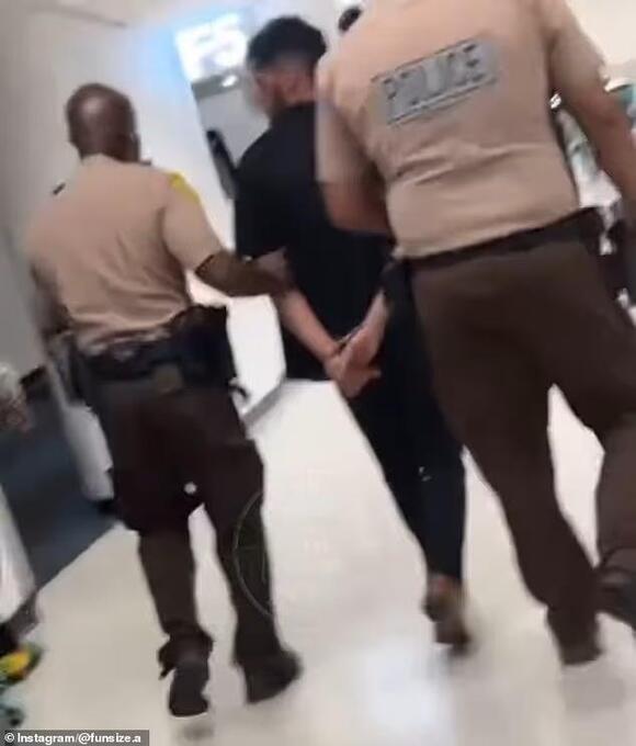 Frontier passenger, 21, seen CACKLING after mid-air brawl has smile ...