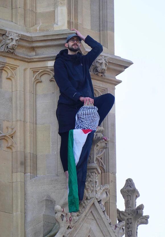 Barefoot man holding a Palestinian flag climbs up Big Ben tower - NewsBreak