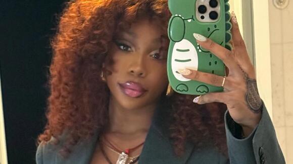 SZA Poses by a Pole in Sheer Top & High-Slit Skirt - NewsBreak