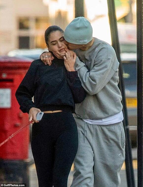 Romeo Beckham shirks family woes as he plants a kiss on girlfriend Kim ...