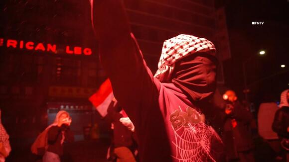 Anti-Israel protesters carry flares to march on NYPD HQ after over 130 ...