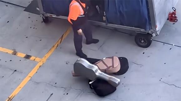 Viral footage shows a baggage handler throwing multiple guitars to the ...