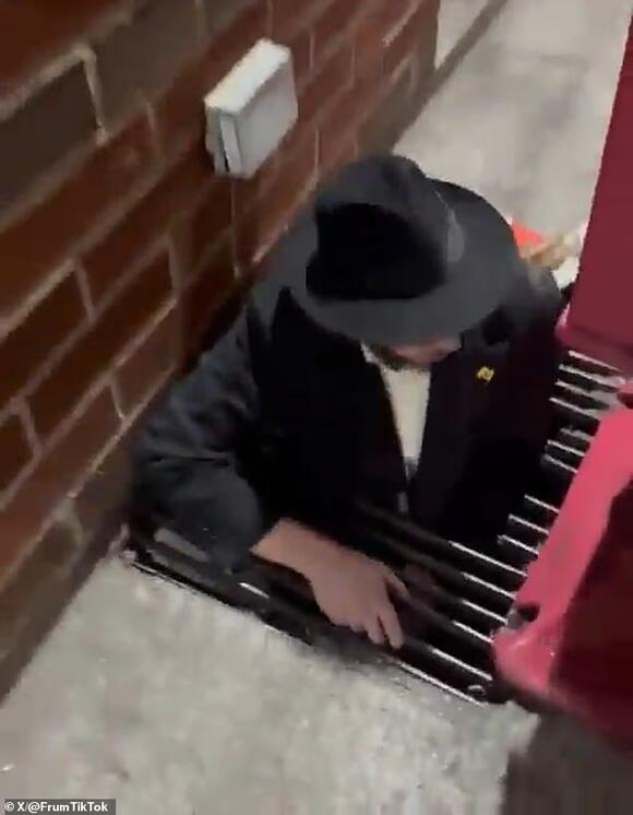 Mystery as large group of men emerge from manhole into middle of busy ...