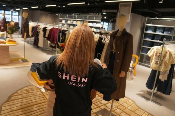 Protesters carry 'Shame on Shein' signs as fast fashion brand opens ...