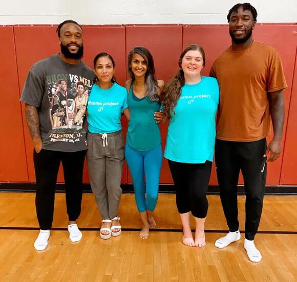 NFL players connect with Carver football team through yoga
