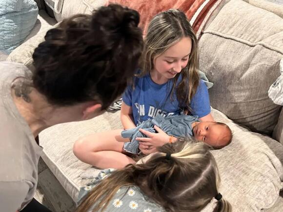 Sisters Surprise Reunion With Baby Brother After NICU Stay - NewsBreak