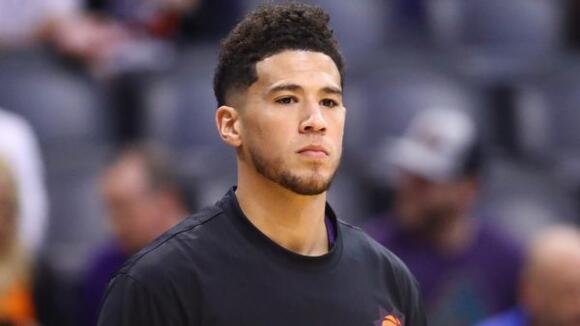Devin Booker towers over Suni Lee in viral photo at Olympics - NewsBreak