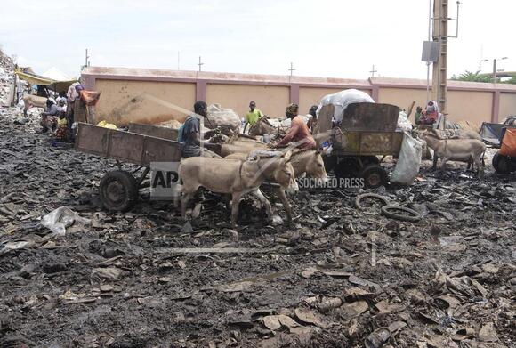 The trash in Mali's capital is piling up. Donkey carts are coming to help