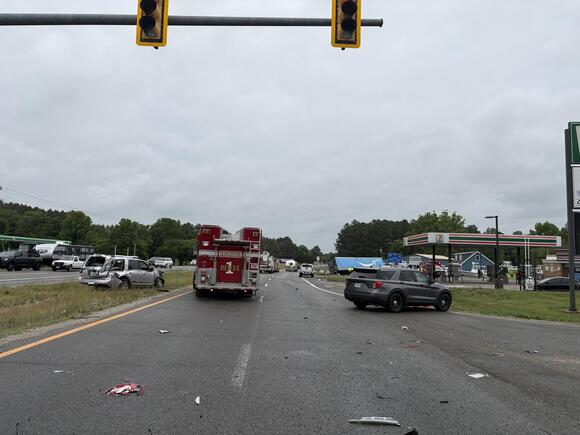 Tractor-trailer runs red light, hits car before striking nearby boats ...