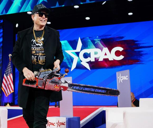 Elon Musk wields ‘chainsaw for bureaucracy’ on stage at CPAC to symbolize DOGE’s massive ...