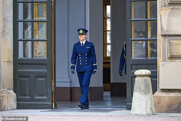 Crown Princess Victoria looks smart in royal blue uniform as she ...