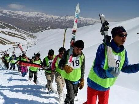 Wearing a hodge-podge of warm clothes and neon pinnies, a long line of ...