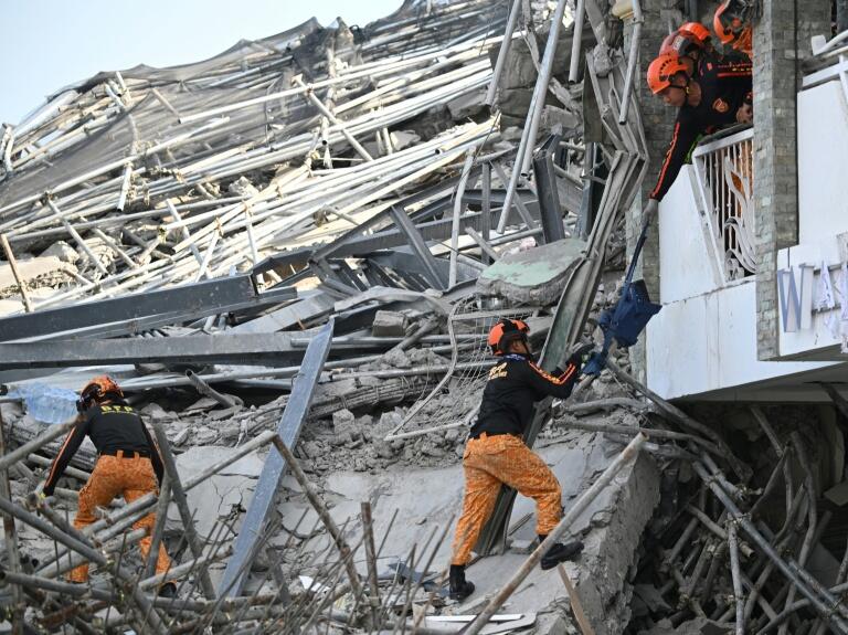 Rescuers search for 20 missing after Philippine building collapse ...