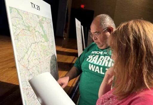 Voters look at a map to understand the new redistricting maps approved ...