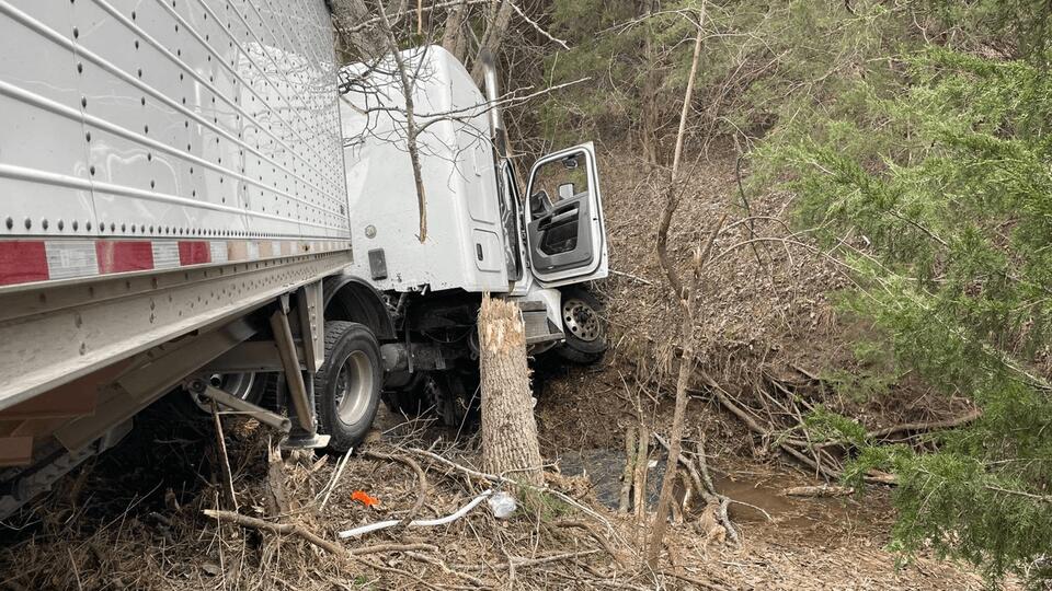 Semi hits bridge, snaps tree in half, crashes in Macon County creekbed ...