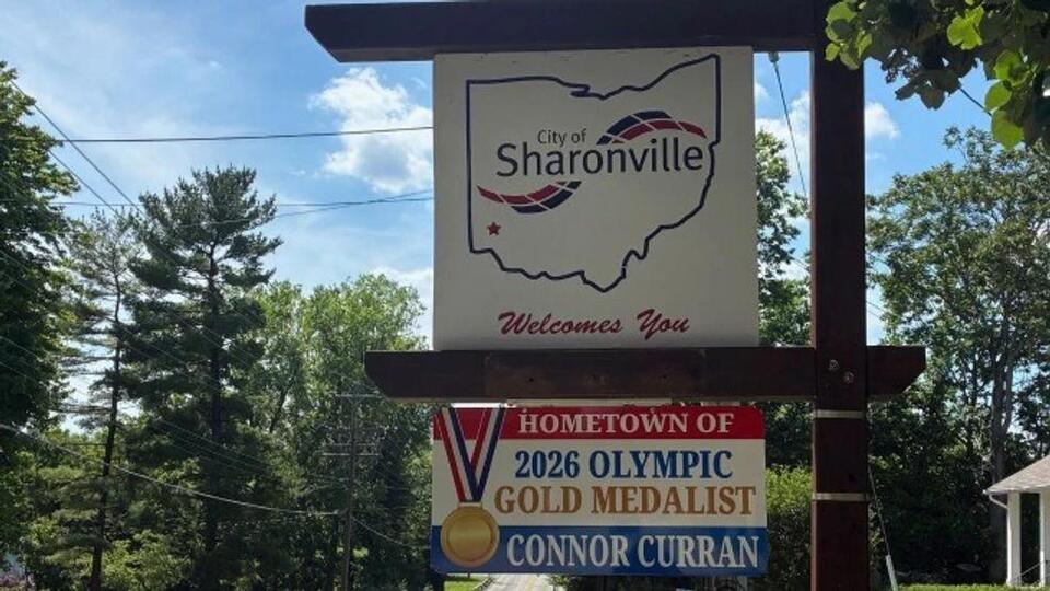 Local community adds sign honoring native son, Olympic gold medalist ...