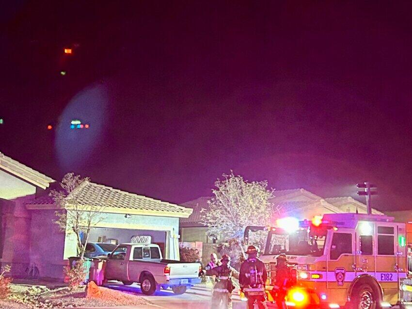 Firefighters rescue an elderly woman from a burning home in Goodyear