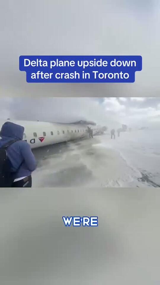 A Delta Airlines plane is seen upside down at Toronto Pearson ...