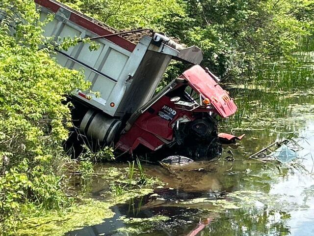 Dump truck crashes into canal near Granger Road