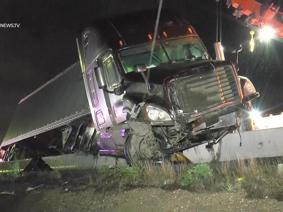 Big Rig Crash on I-5 Leaves Truck Precariously Perched on K-Rail