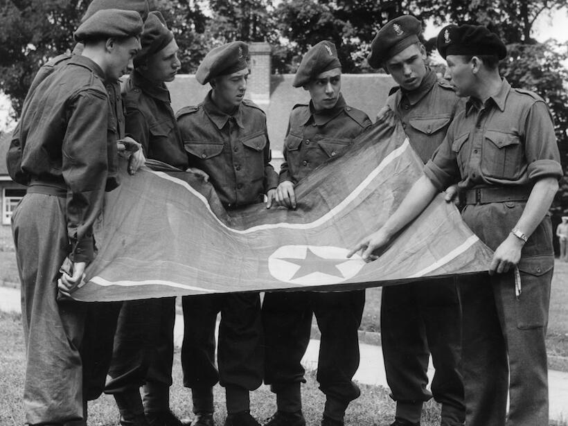 9 Photos of US Troops Displaying Enemy Flags Like Trophies