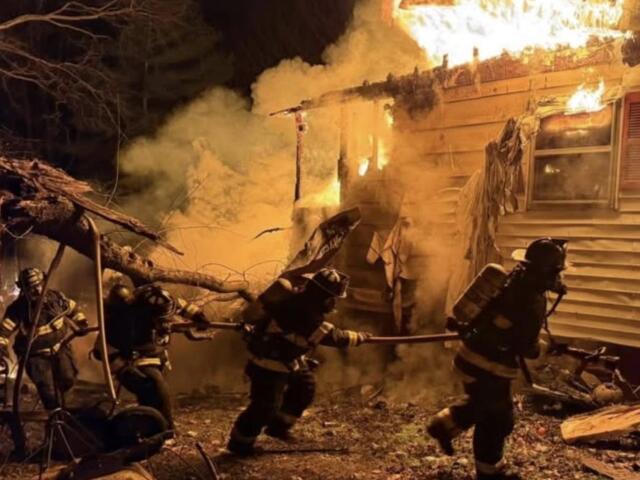 Powerful footage shows rescue teams battling home engulfed in fire in ...
