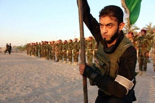 A member of the Iraqi Shiite Muslim Mehdi Army, which also fought in ...