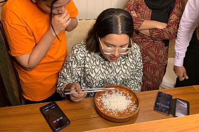 Watch: Woman uses chopsticks to eat one grain of rice at a time - NewsBreak