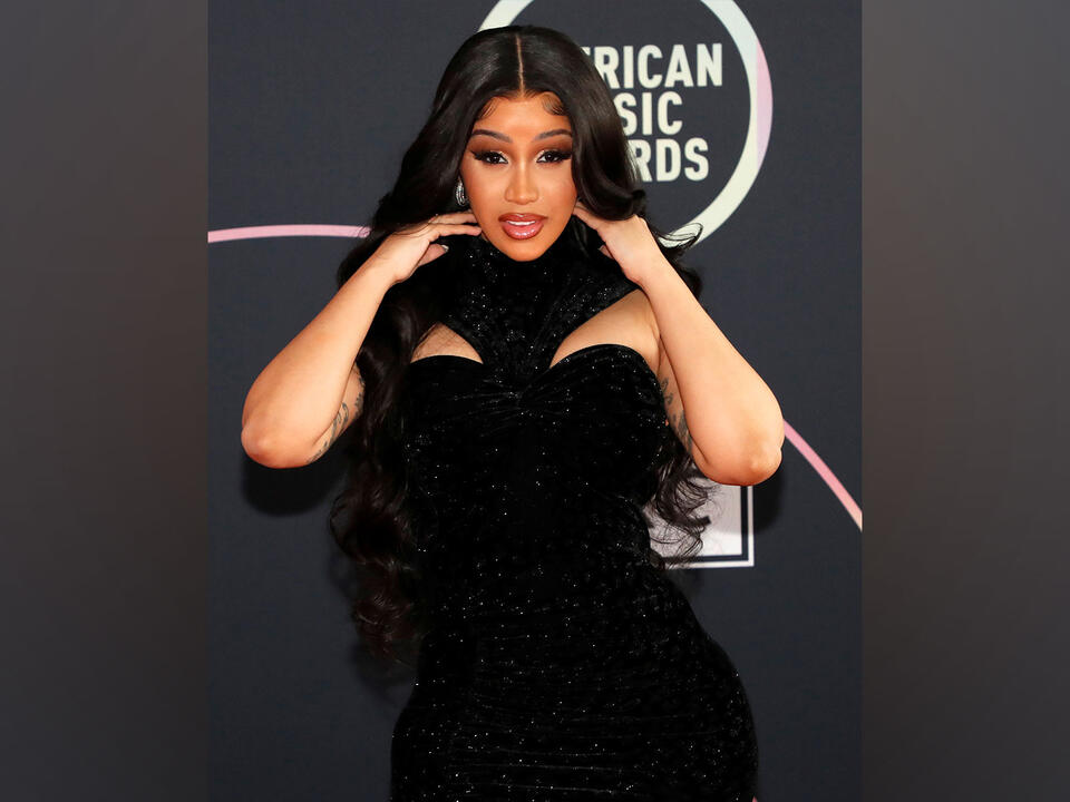 Cardi B takes tumble while playfully dancing with robot ahead of Super ...