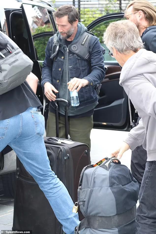 Keanu Reeves, 59, looks youthful in a blue denim jacket as he arrives ...