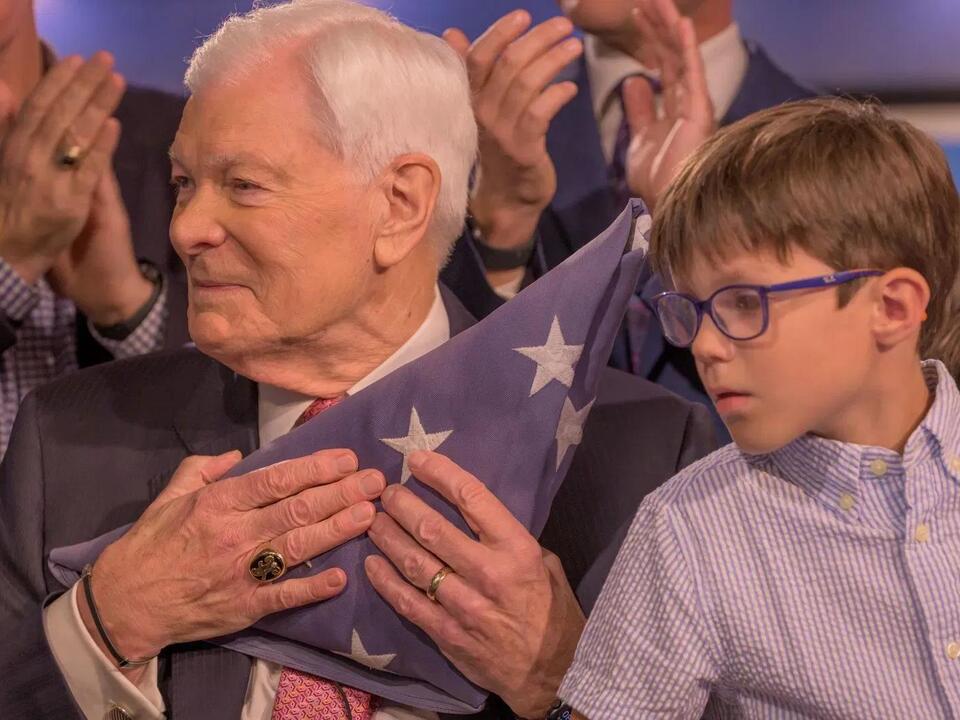 Don Alhart presented with Channel 13's American flag