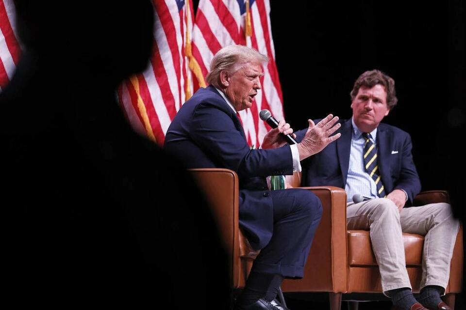Trump defends Tucker Carlson after interview with activist known for ...