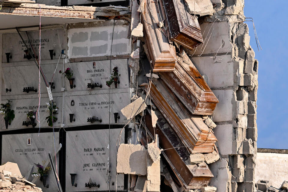 Chilling pics show coffins dangling in mid-air and corpses laying bare ...