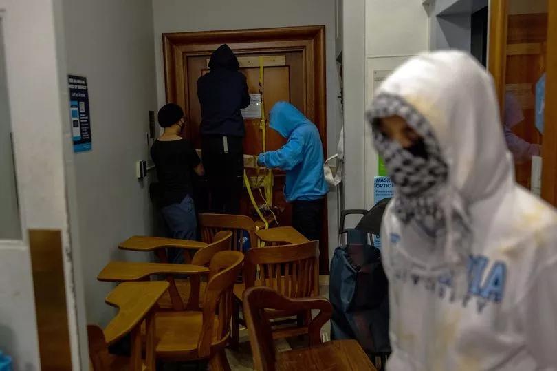 Columbia University suspends students as masked protesters take over ...