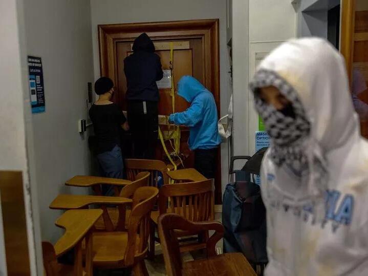 Columbia University suspends students as masked protesters take over ...