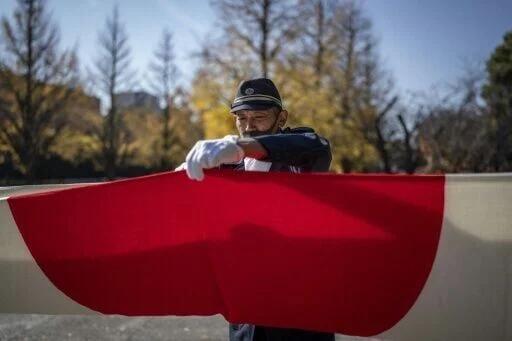 A member of the ultra-nationalist group Taikosha folds a Japanese ...