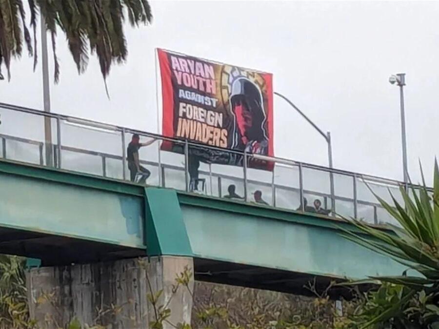Discriminatory group display offensive sign on bridge Saturday morning