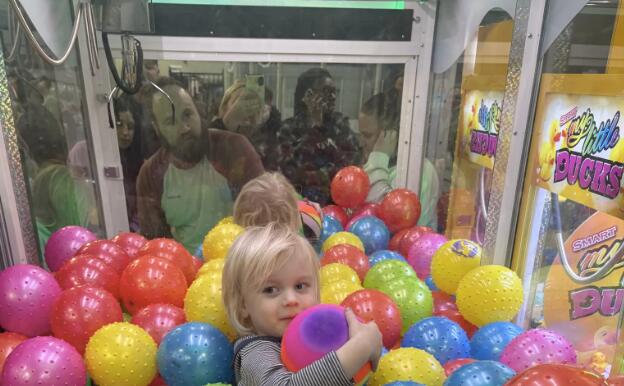 WATCH: Happy Toddler Climbs Into Claw Machine And Gets Stuck - NewsBreak