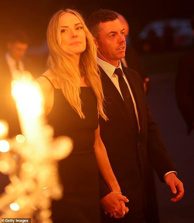 Feeling below par Rory? McIlroy and wife Erica Stoll look glum as they ...