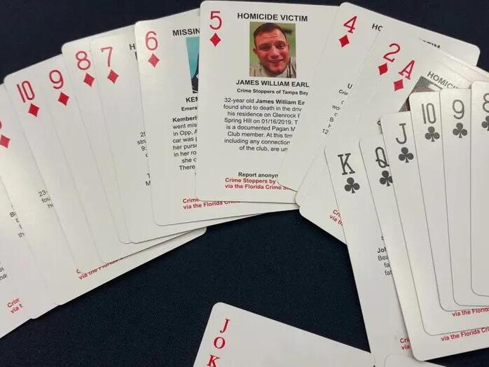 Playing cards with faces and stories of unsolved victims being used to ...