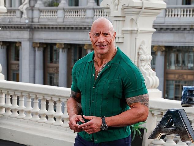 Dwayne 'The Rock' Johnson shows off his bulging biceps and macular ...